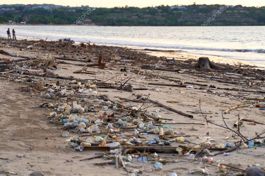 Mountains of waste and garbage on the sandy beach after the tide ...