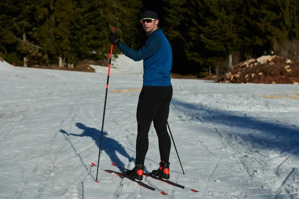 Nordic skiing or Cross-country skiing classic technique practiced by man in a beautiful ...