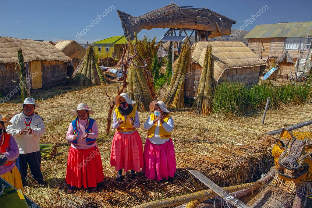 Uros, Peru - April 29, 2022: women in traditional dresses near house on ...