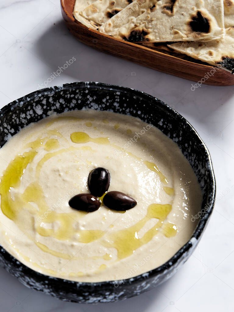 Taramasalata in the bowl with olive oil and black olive. Taramasalata ...