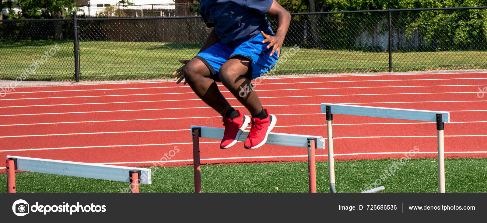 Side View African American Athlete Jumping Hurdles Turf Field Practice ...