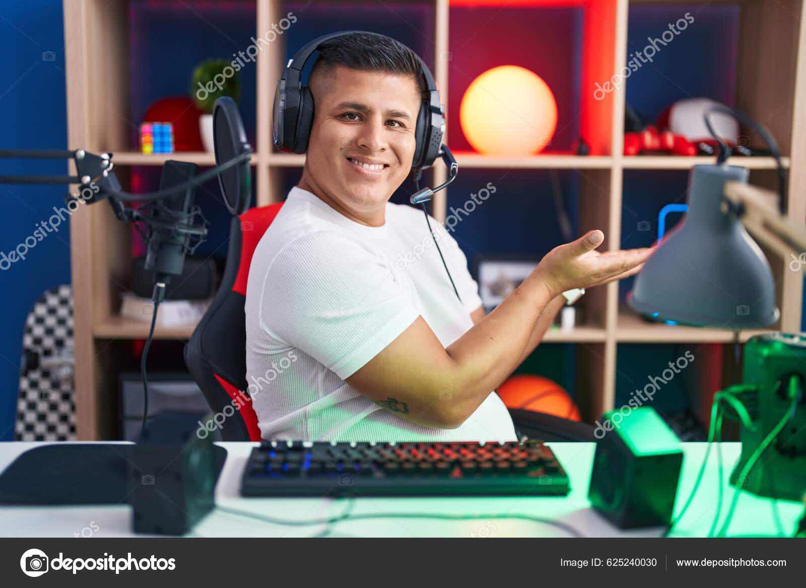 Young Hispanic Man Playing Video Games Pointing Aside Hands Open ...