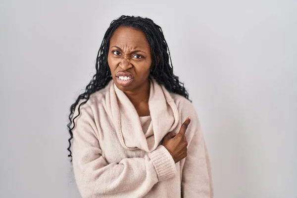 African woman standing over white background pointing aside worried and ...