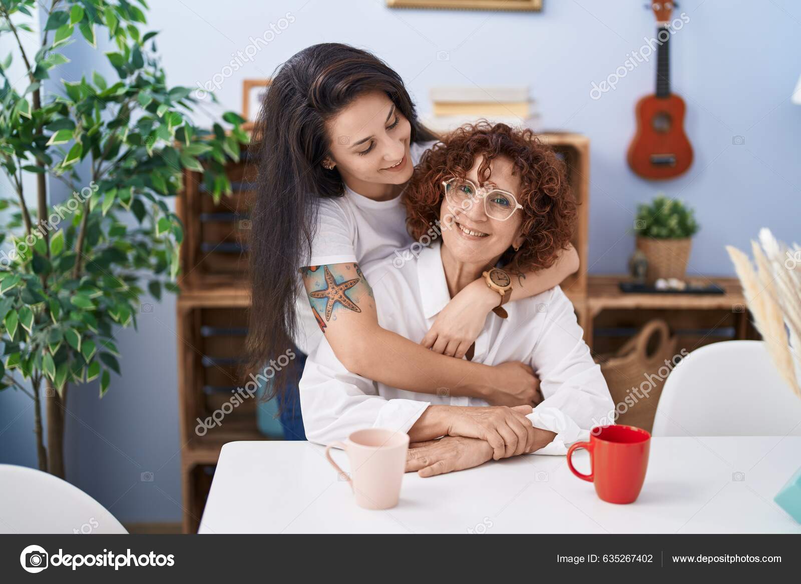 Two Women Mother Daughter Drinking Coffee Hugging Each Other Home Stock
