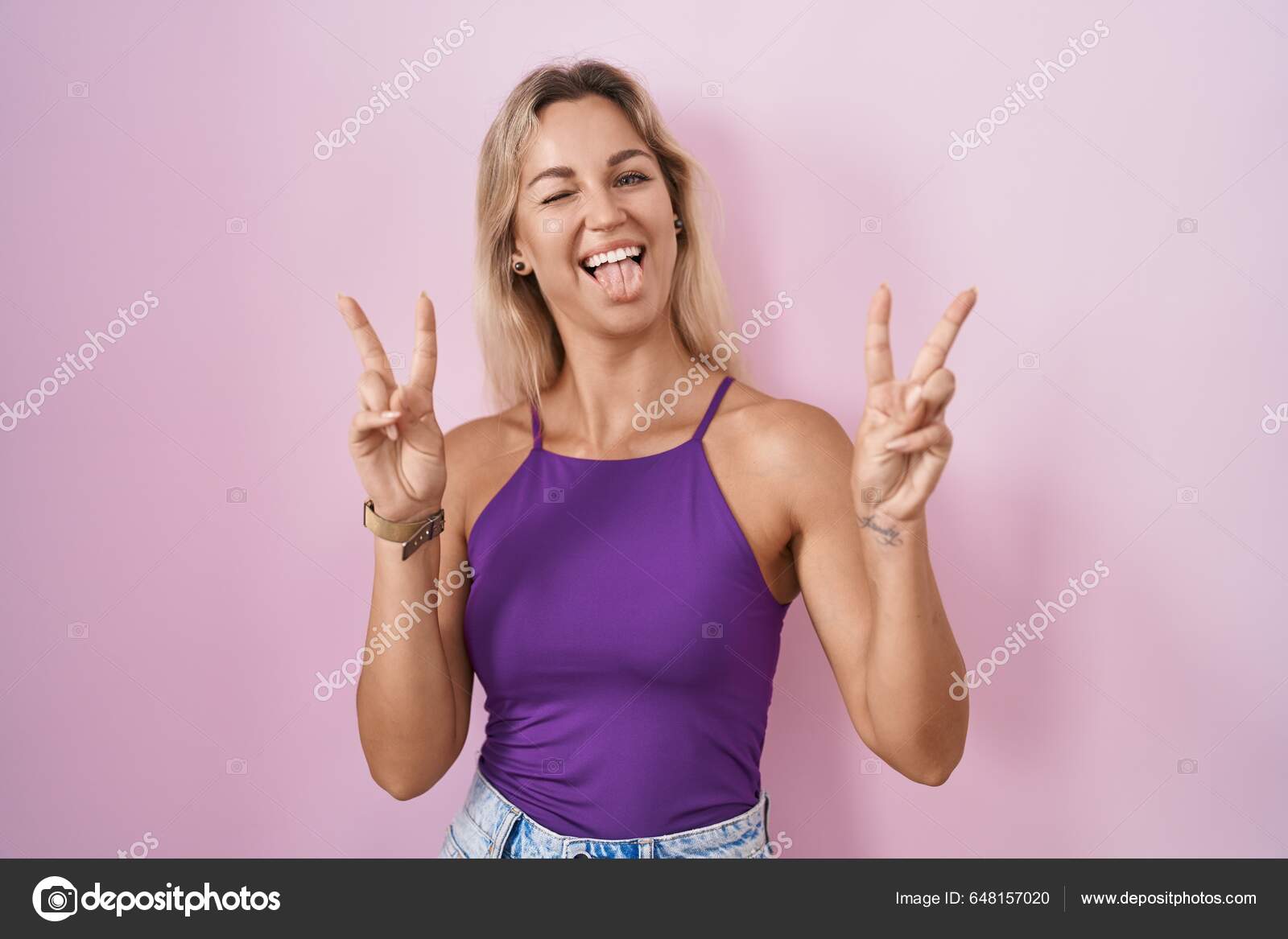 Young Blonde Woman Standing Pink Background Smiling Tongue Out Showing