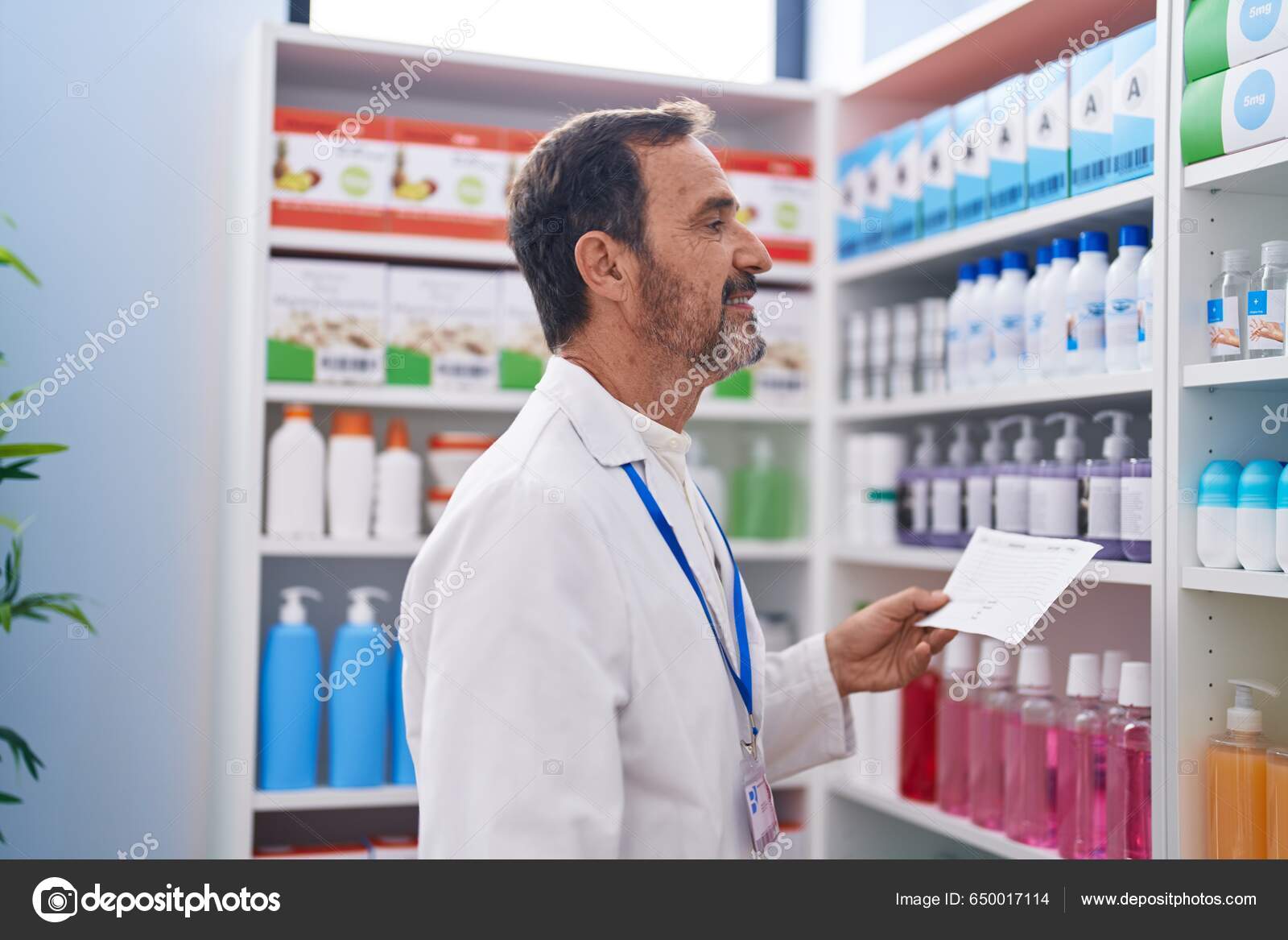 Middle Age Man Pharmacist Holding Prescription Looking Shelving ...
