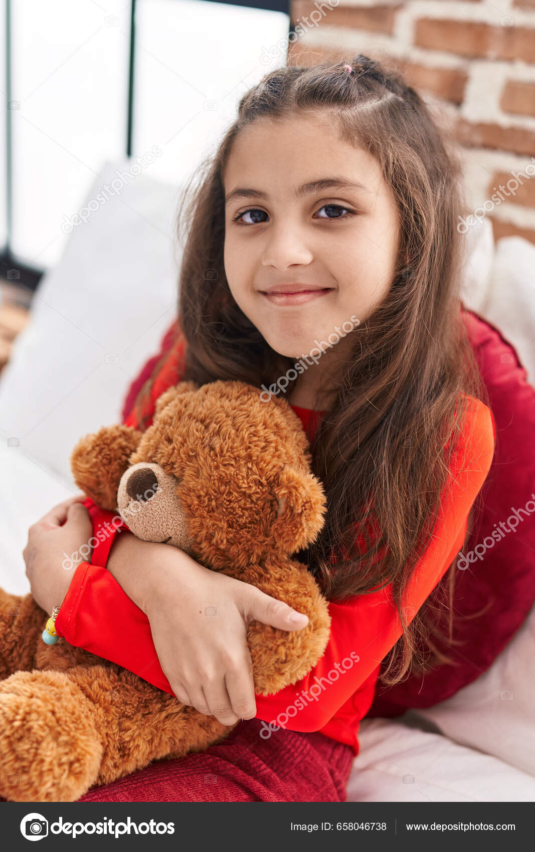 Adorable Hispanic Girl Hugging Teddy Bear Sitting Bed Bedroom Stock