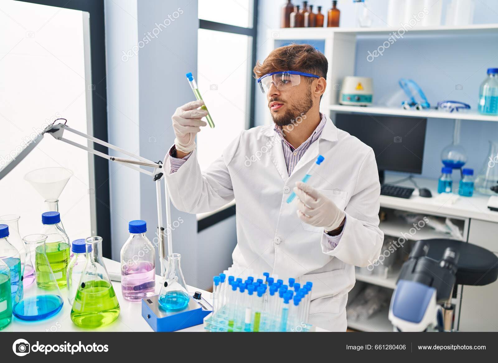 Young Arab Man Scientist Measuring Liquid Holding Test Tubes Laboratory ...