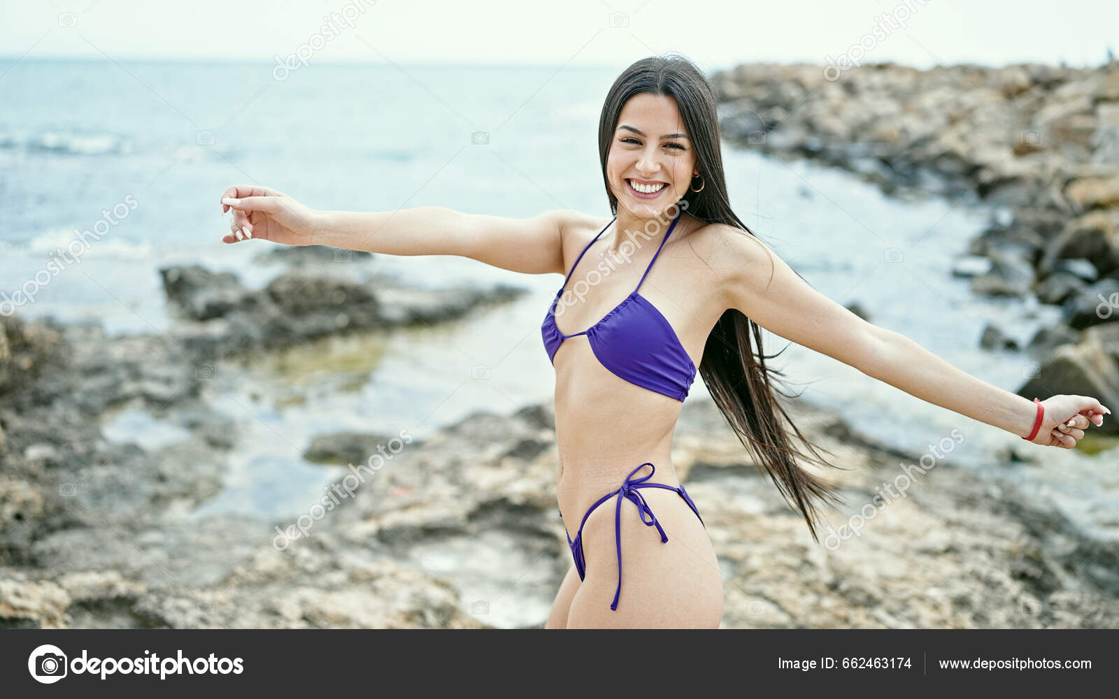 Young Beautiful Hispanic Woman Tourist Wearing Bikini Standing Arms ... Young Beautiful Hispanic Woman Tourist Wearing Bikini Standing Arms ...