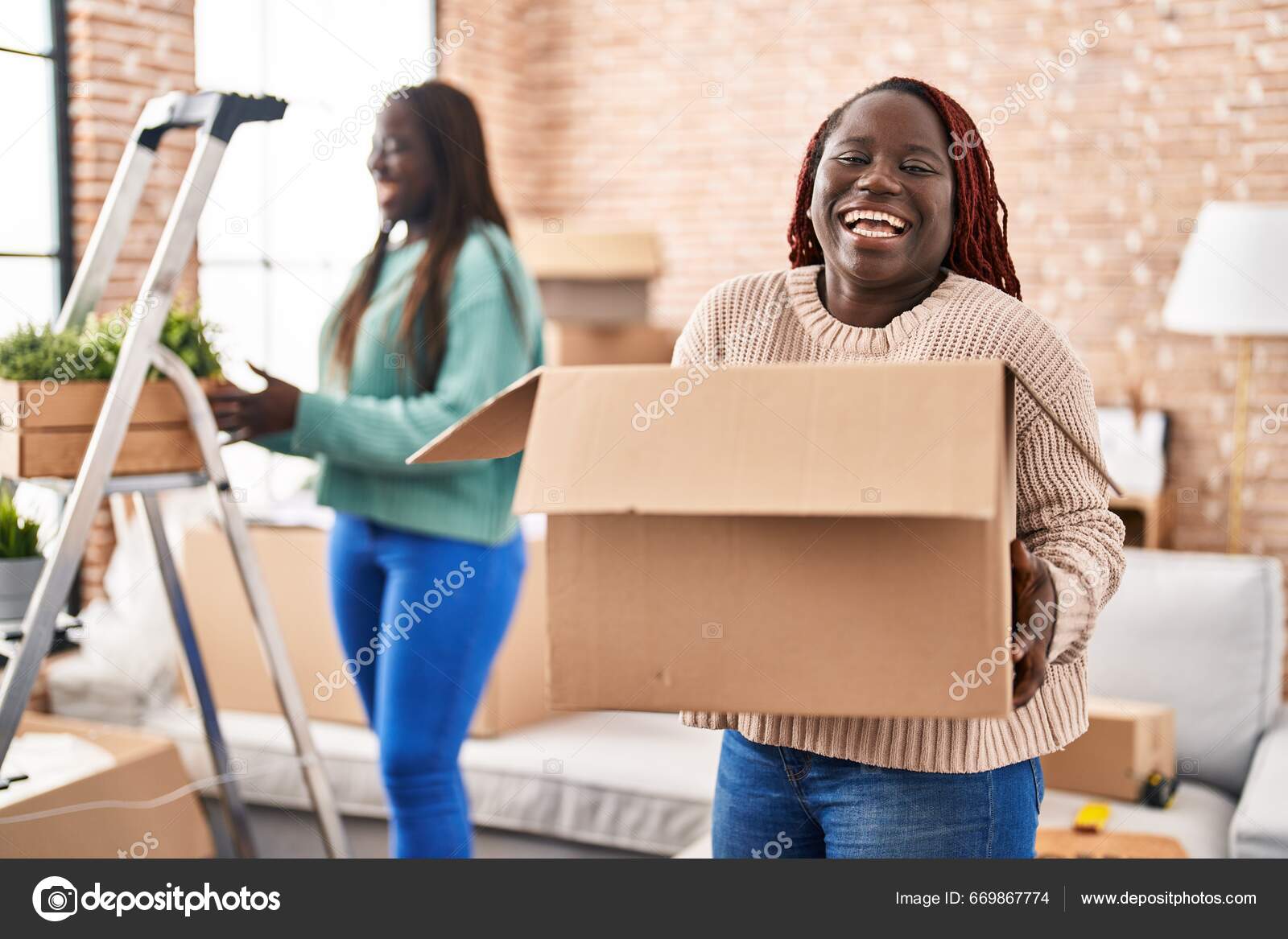 Two African Women Moving New Home Smiling Laughing Hard Out Stock Photo ...