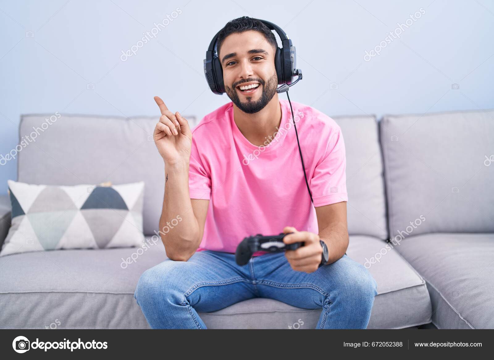 Hispanic Young Man Playing Video Game Holding Controller Sitting Sofa ...