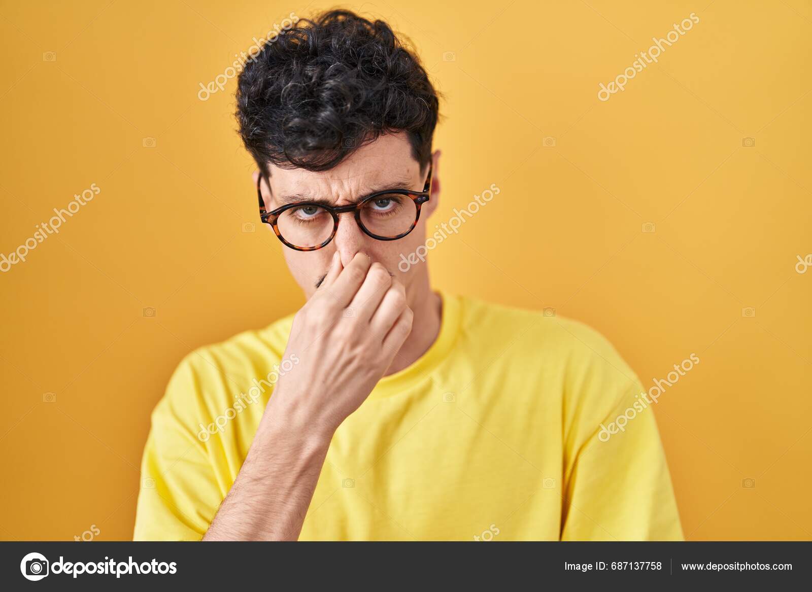 Hispanic Man Wearing Glasses Standing Yellow Background Smelling ...