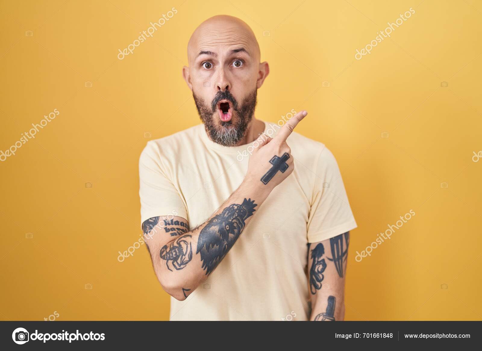 Hispanic Man Tattoos Standing Yellow Background Surprised Pointing ...