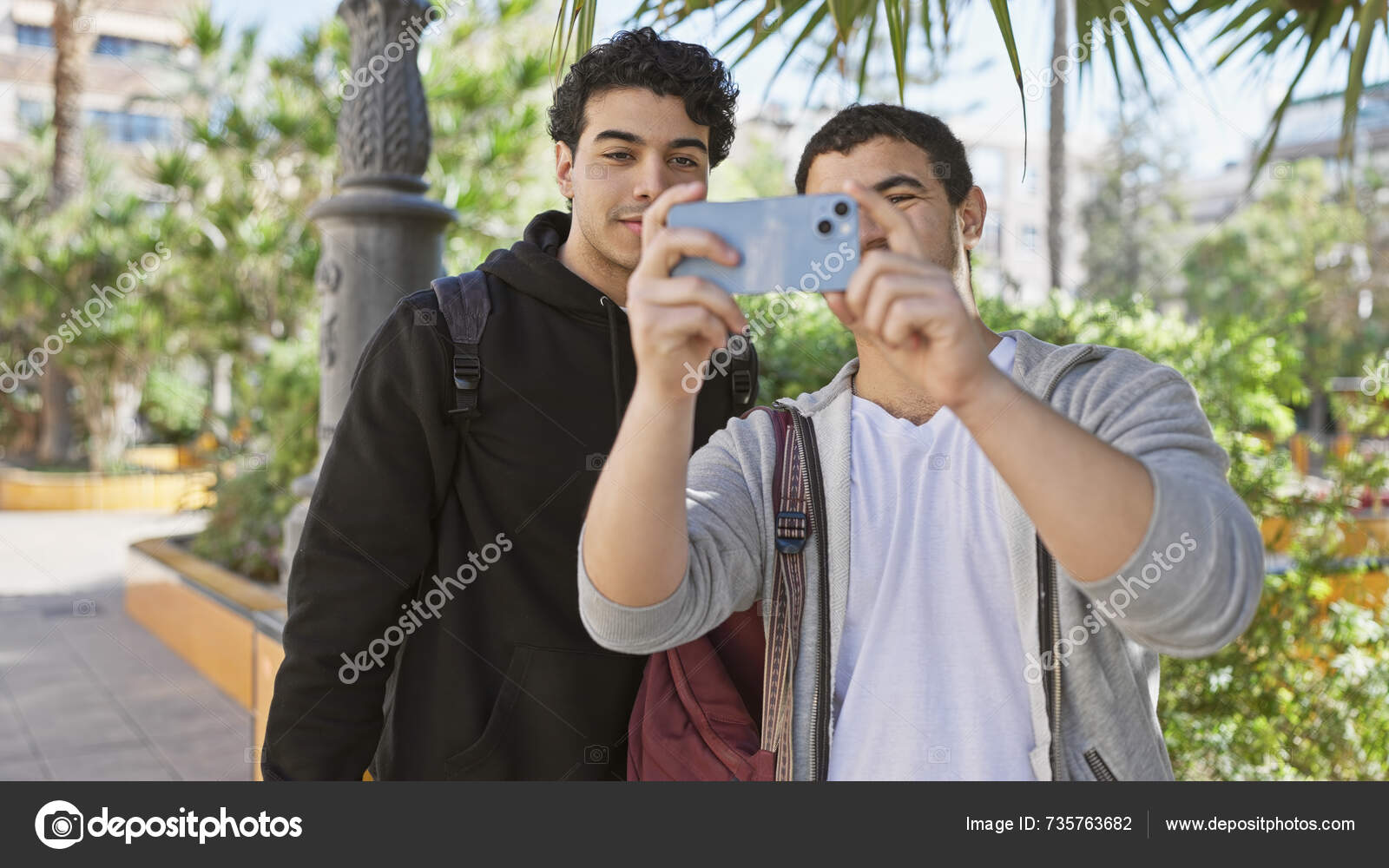 Two Men Taking Selfie Outdoors Lush Greenery Park Setting Embodying ...