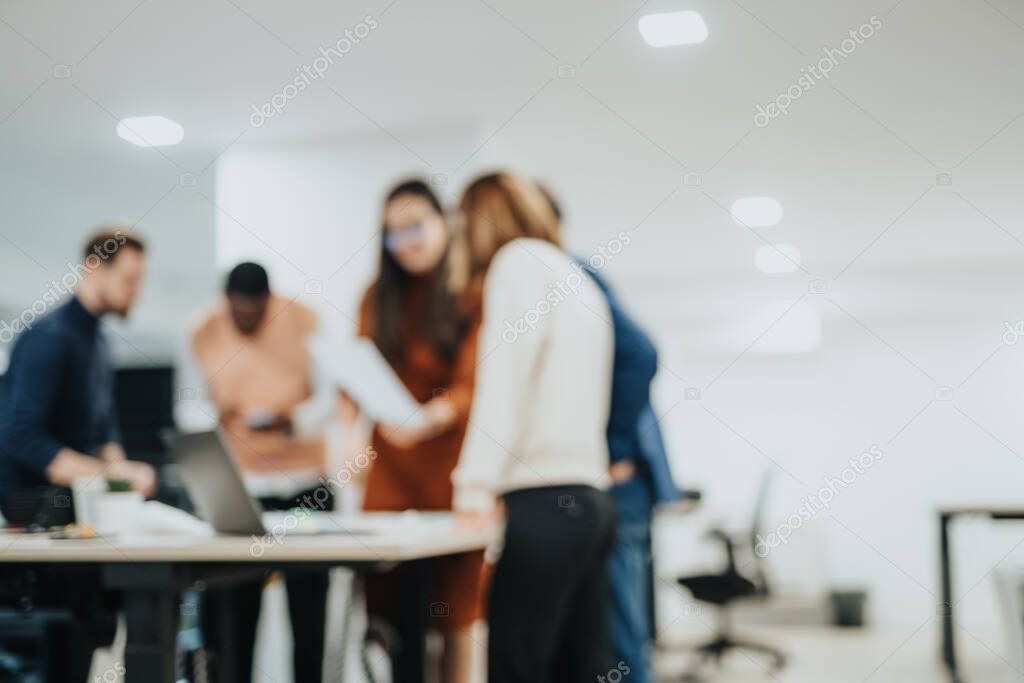 Un equipo diverso y cooperativo de empresarios que trabajan hasta altas horas de la noche en una ...