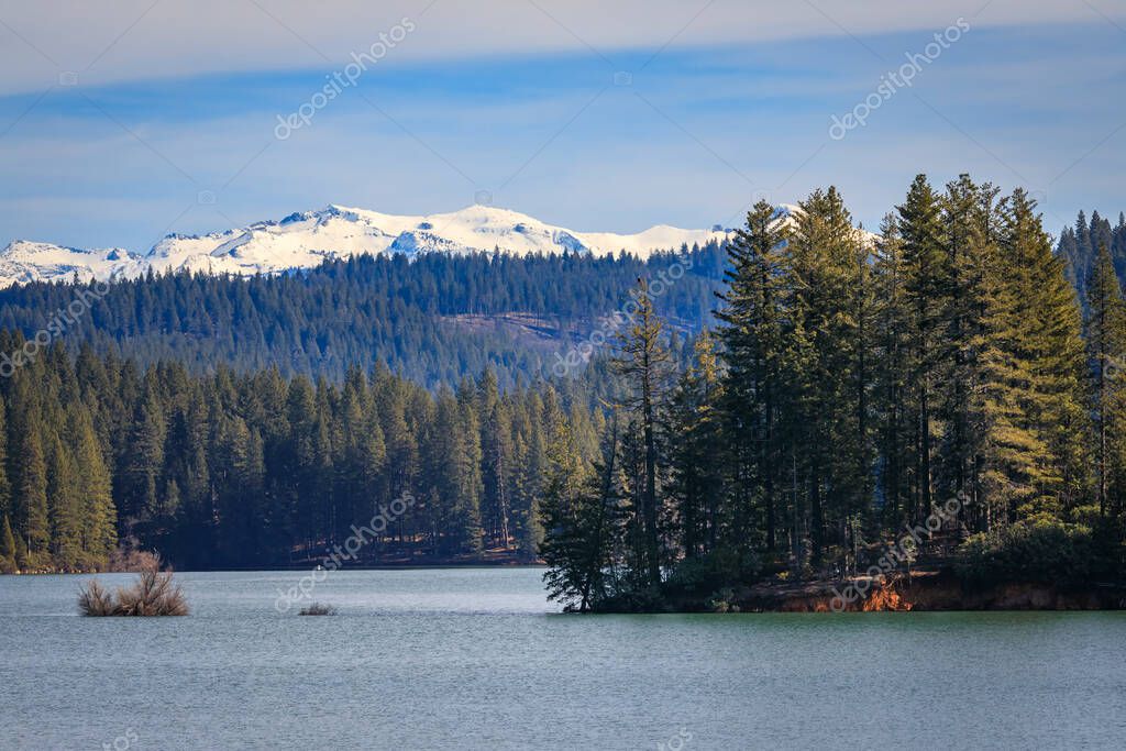 Jenkinson Lake en Sly Park y nevado Sierra Nevada Montañas en el fondo ...