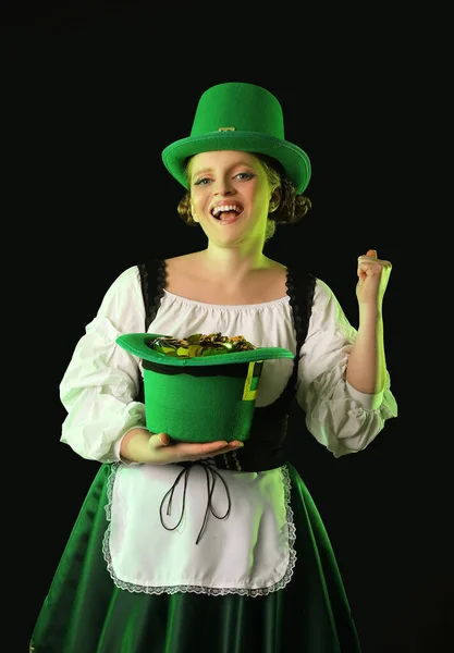 Irish waitress with hat of confetti on dark background. St. Patrick's ...
