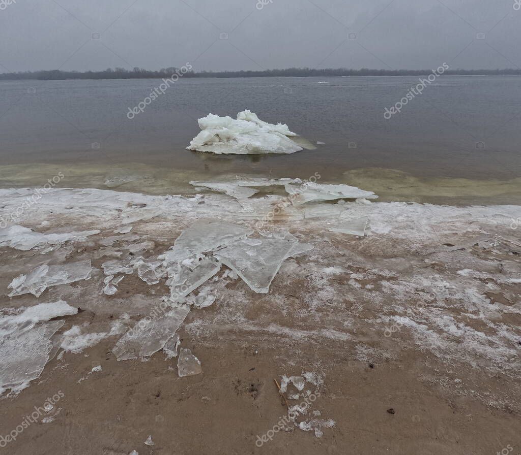 blocks of ice on the shore. big ice floes on the sand. Melting ice ...