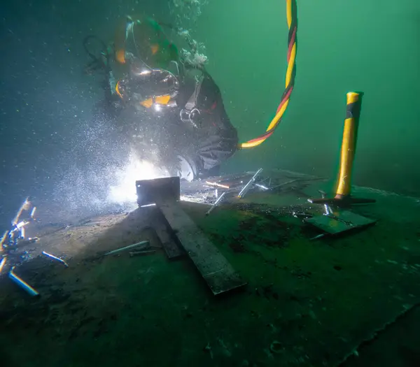 Underwater welding in deep ocean depths closeup - Stock Image - Everypixel
