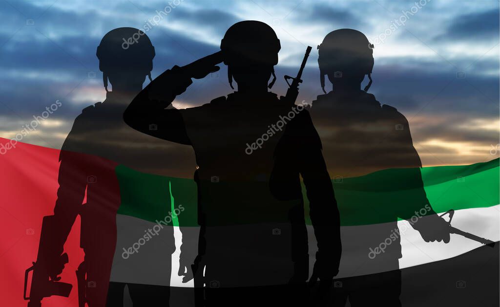 Silhouette of a soldiers on background of the sunrise and UAE flag ...