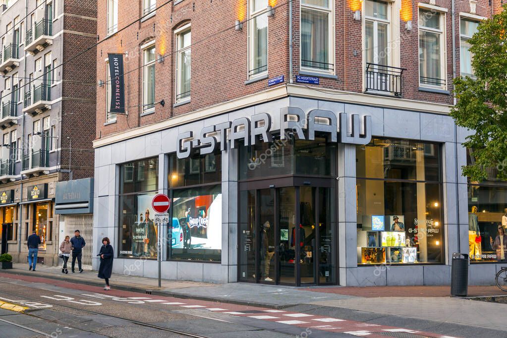 Amsterdam, NL - OCT 12, 2021: Entrance and logo of G-Star Raw Amsterdam store. G-Star RAW is a ...