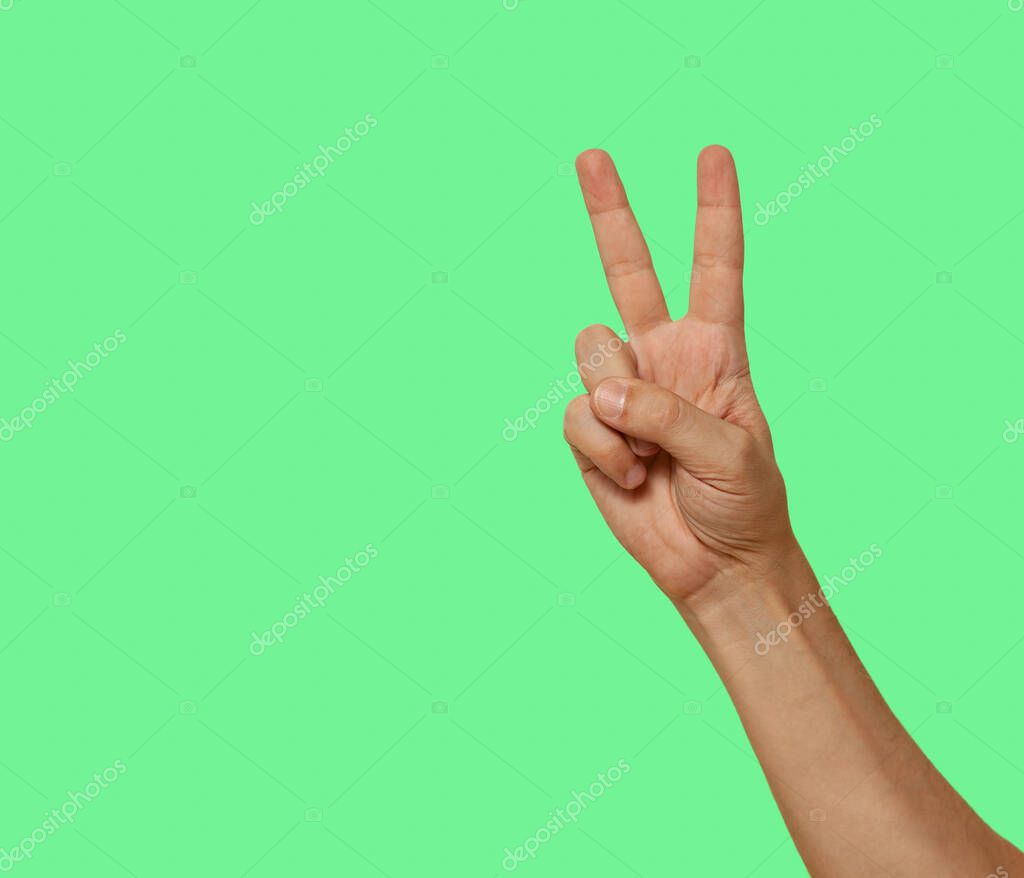 Victoria sign on isolated on green chroma key background. A bare hand ...
