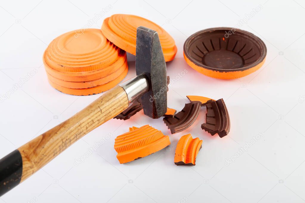 Test of strength. The hammer breaks the clay target. There are several ...