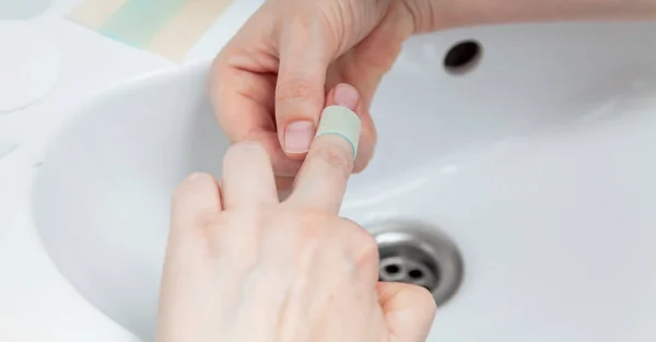 Prevention of small cuts of the hand. The right hand sticks a narrow ...