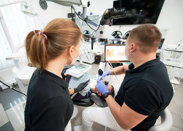 Dentist scanning patients teeth with modern machine for intraoral ...