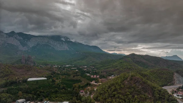 Top view of the hilly green area. Houses in the green forest. Timelapse ...