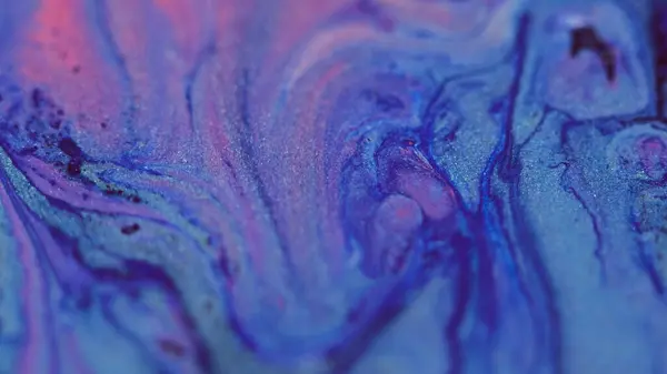Paint spill. Glitter ink mix. Defocused neon blue pink purple color ...