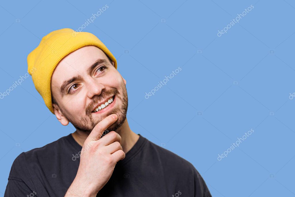 Tipo pensante mirando hacia arriba y alrededor sobre fondo azul. Tipo ...