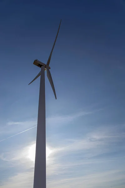 Close-up of a windmill. Blue sky and the sun in the background ...