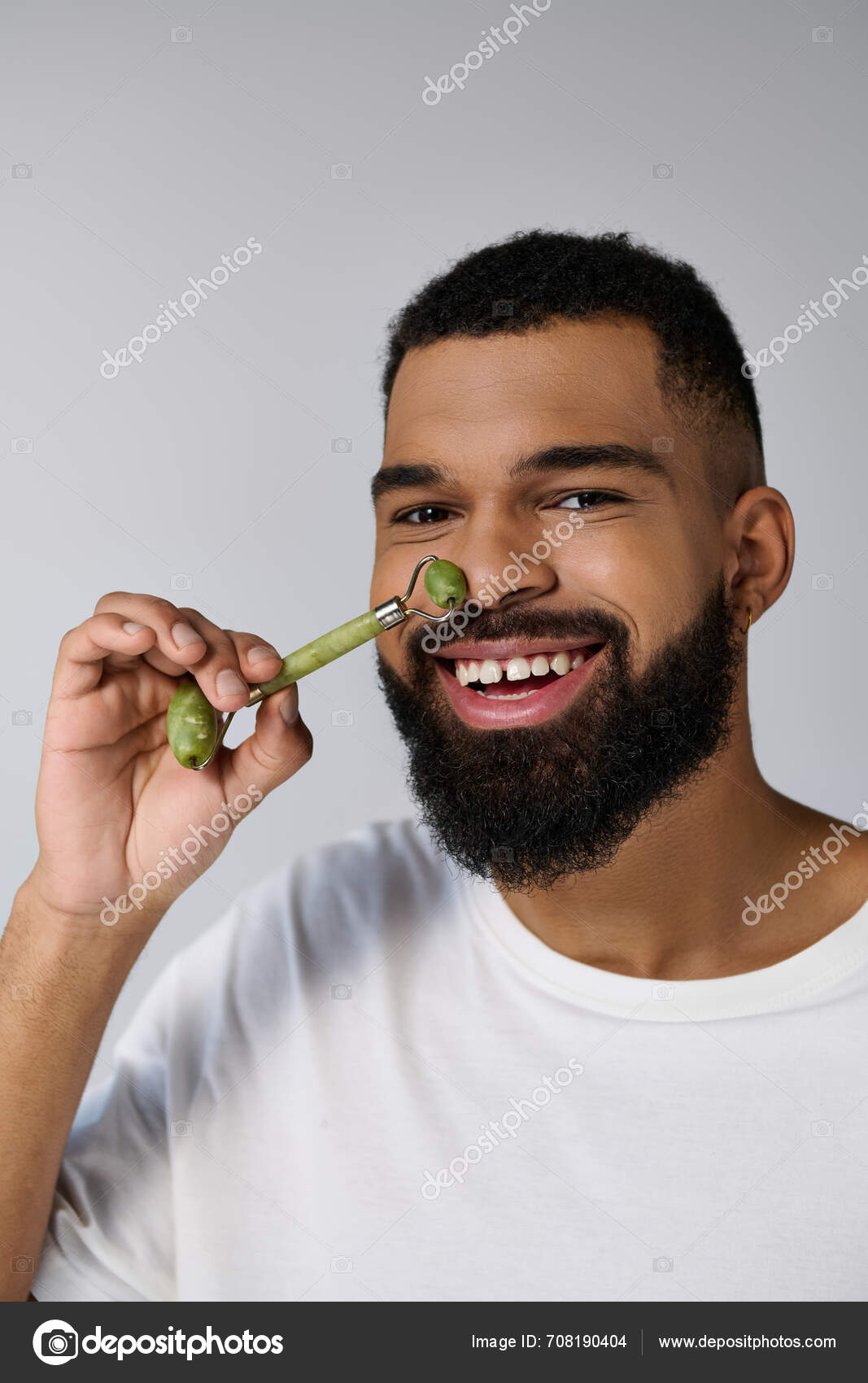 African American Appealing Man Holds Face Roller Skincare Routine ... African American Appealing Man Holds Face Roller Skincare Routine ...