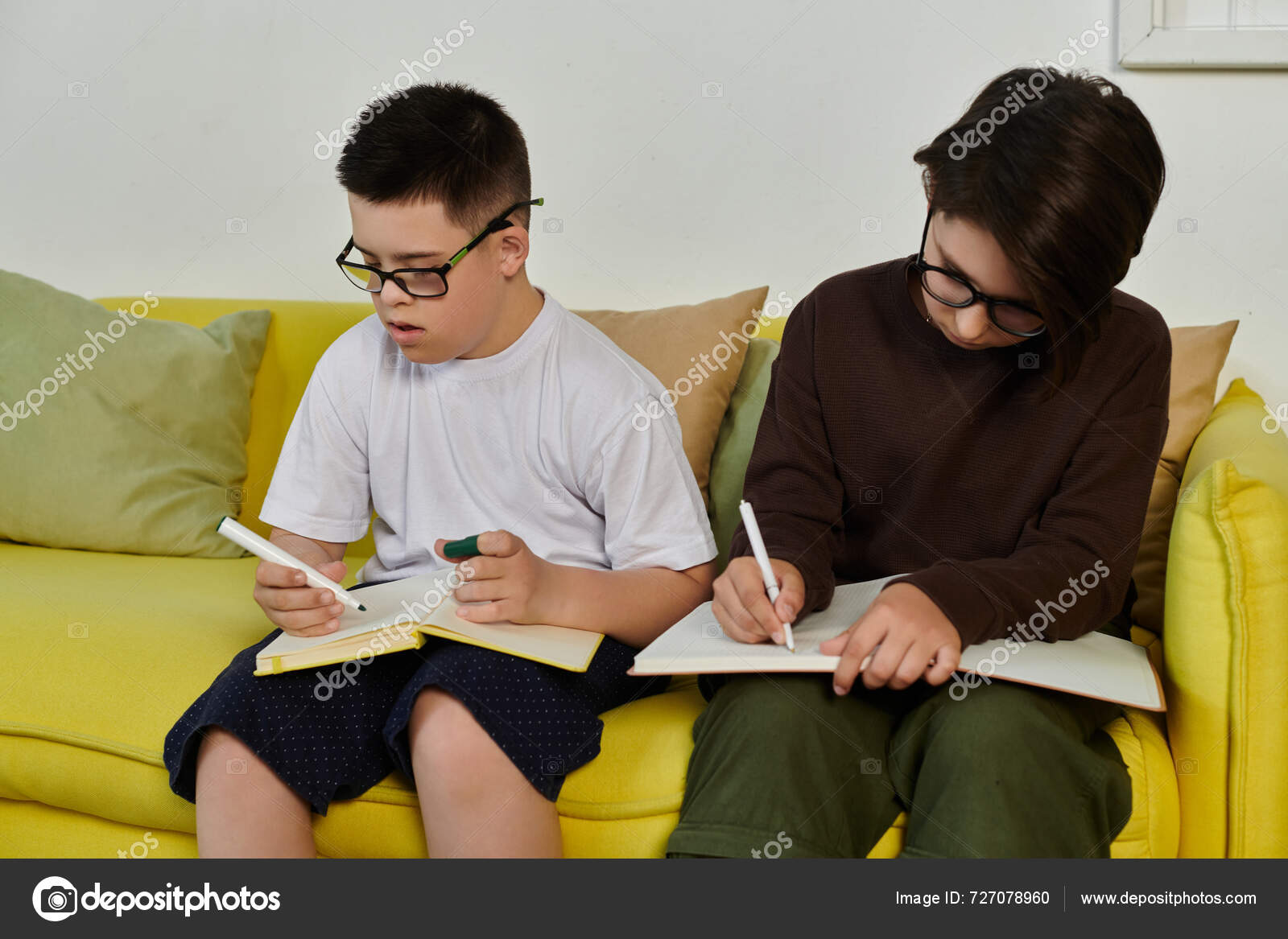 Two Young Boys One Syndrome Sit Yellow Couch Write Notebooks — Stock ...
