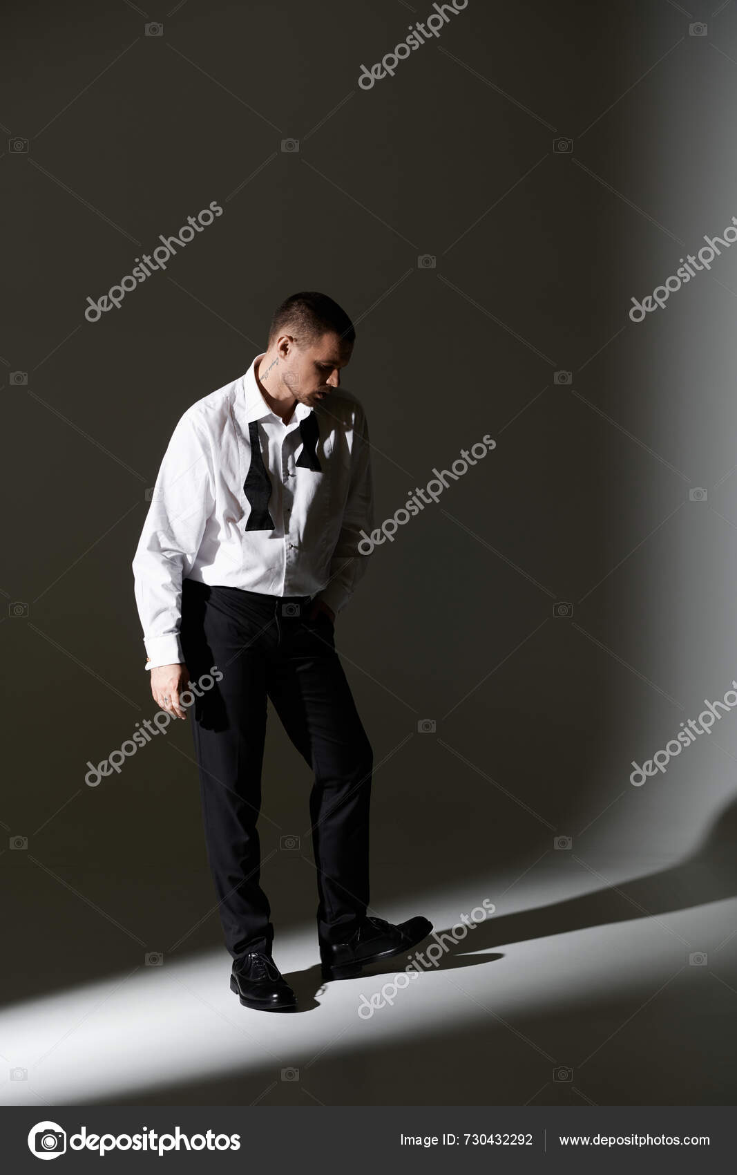 Man White Shirt Black Bow Tie Stands Beam Light Looking — Stock Photo ...
