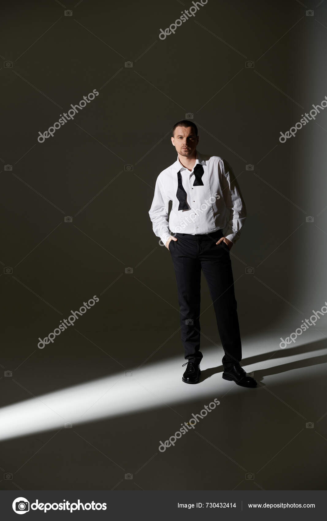 Man White Shirt Black Bowtie Stands Spotlight Looking Intensely Camera ...