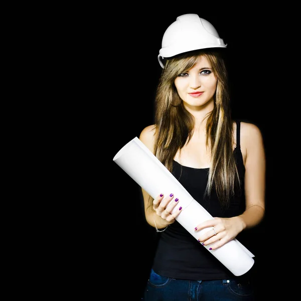 Happy smiling graduate engineer in hardhat holding construction design ...