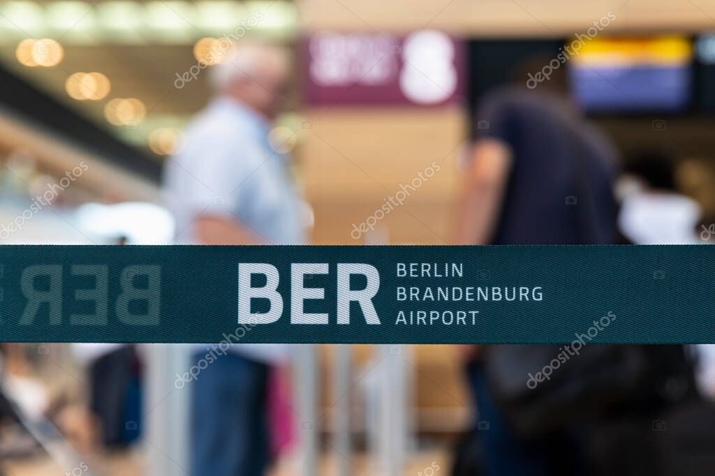 Close-up detail view of BER code Berlin Brandenburg airport logo security barrier tape divider ...
