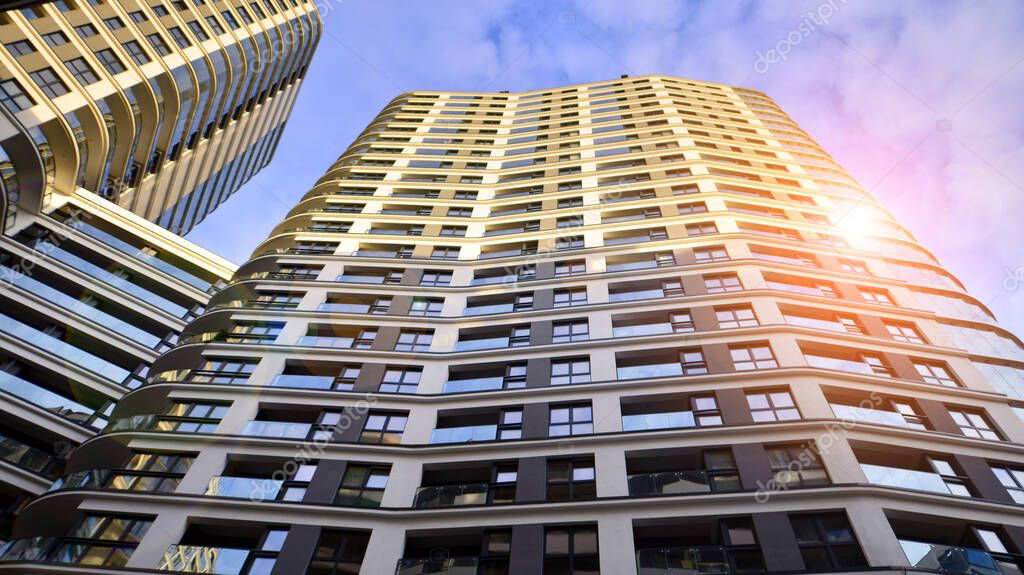 The narrow passage between modern residential buildings. Walls of high ...