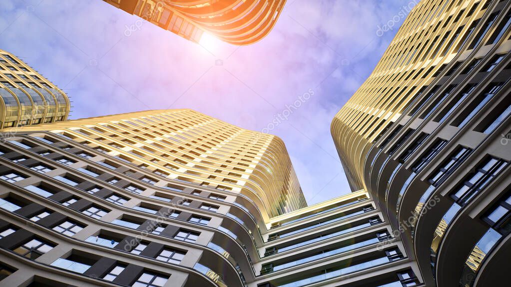 The narrow passage between modern residential buildings. Walls of high ...