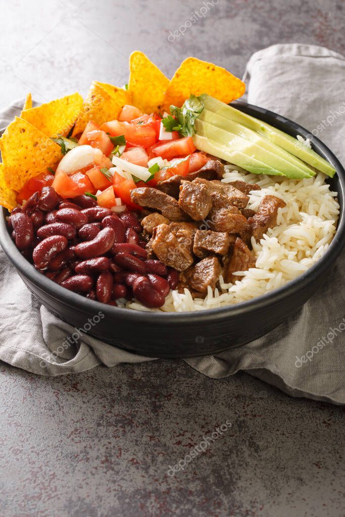 Chifrijo Costa Rican Crispy Pork, Rice and Beans closeup on the plate ...