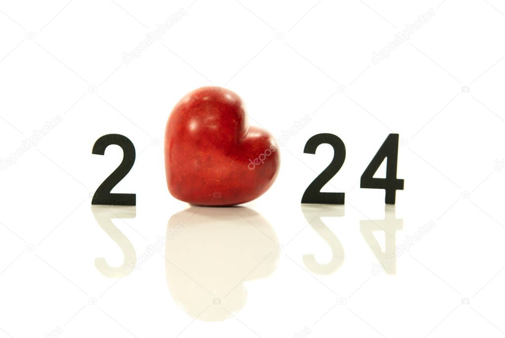 red heart with the year 2024 on a white isolated background to indicate ...
