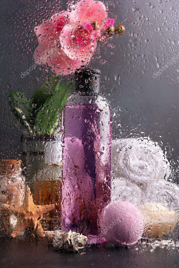 Pink shower gel, bath bomb and sea salt with orchid flower and white ...