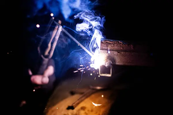 smoke and sparks close-up from electric arc welding in the dark - Stock ...