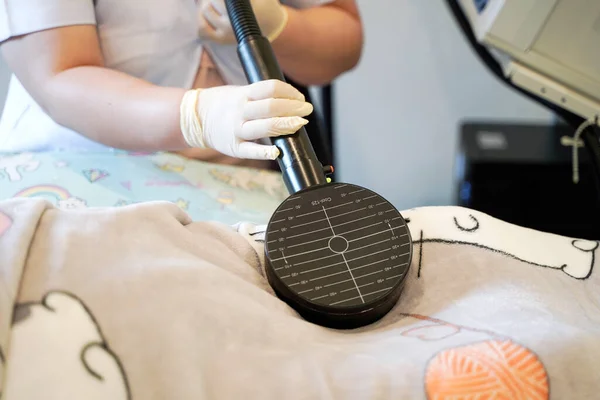 Closeup hands of doctor using electrical muscle stimulation (EMS) on ...