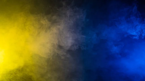 Yellow-blue smoke in neon light on black background. — Stock Photo ...