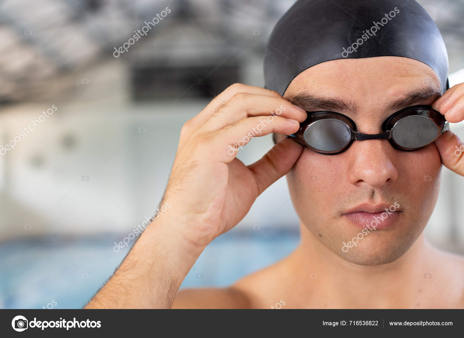 Caucasian Young Male Swimmer Adjusting Goggles Indoors Standing Pool ...