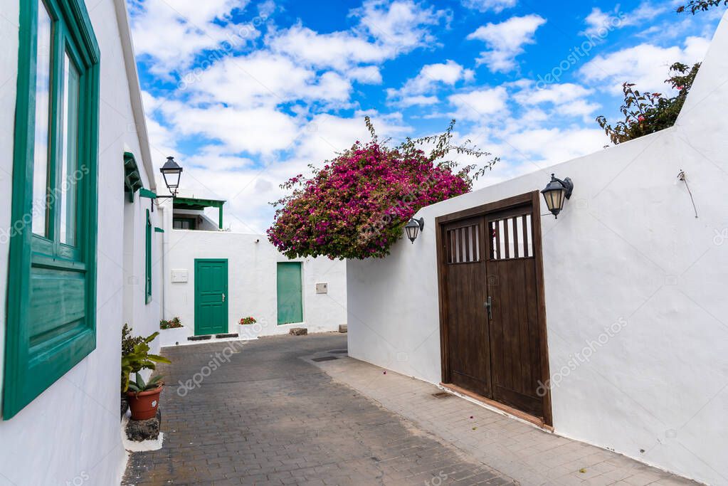 Typical street of the town of Teguise in Lanzarote with a bougainvillea ...