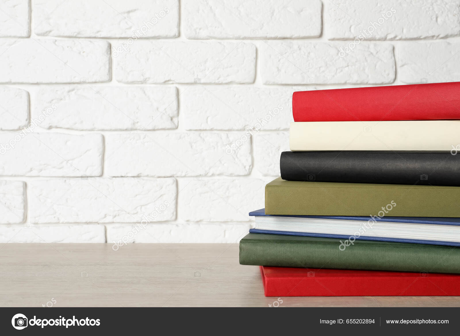 Stack Hardcover Books Grey Table White Brick Wall Space Text — Stock ...